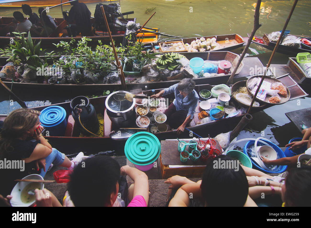 A scene at a floating market where boats are filled with fresh food ...