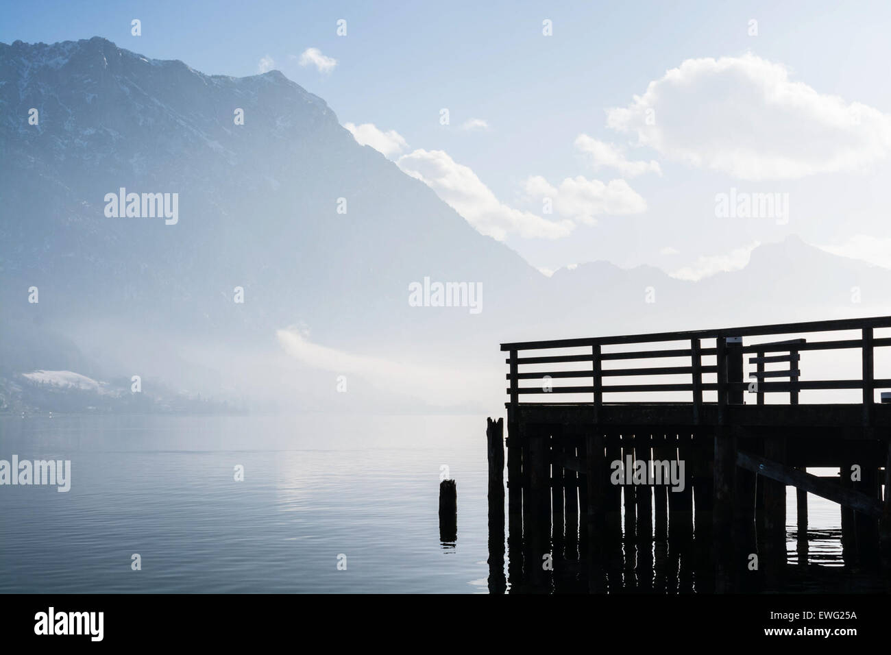 A scenic boardwalk stretches along the edge of a misty mountainside ...