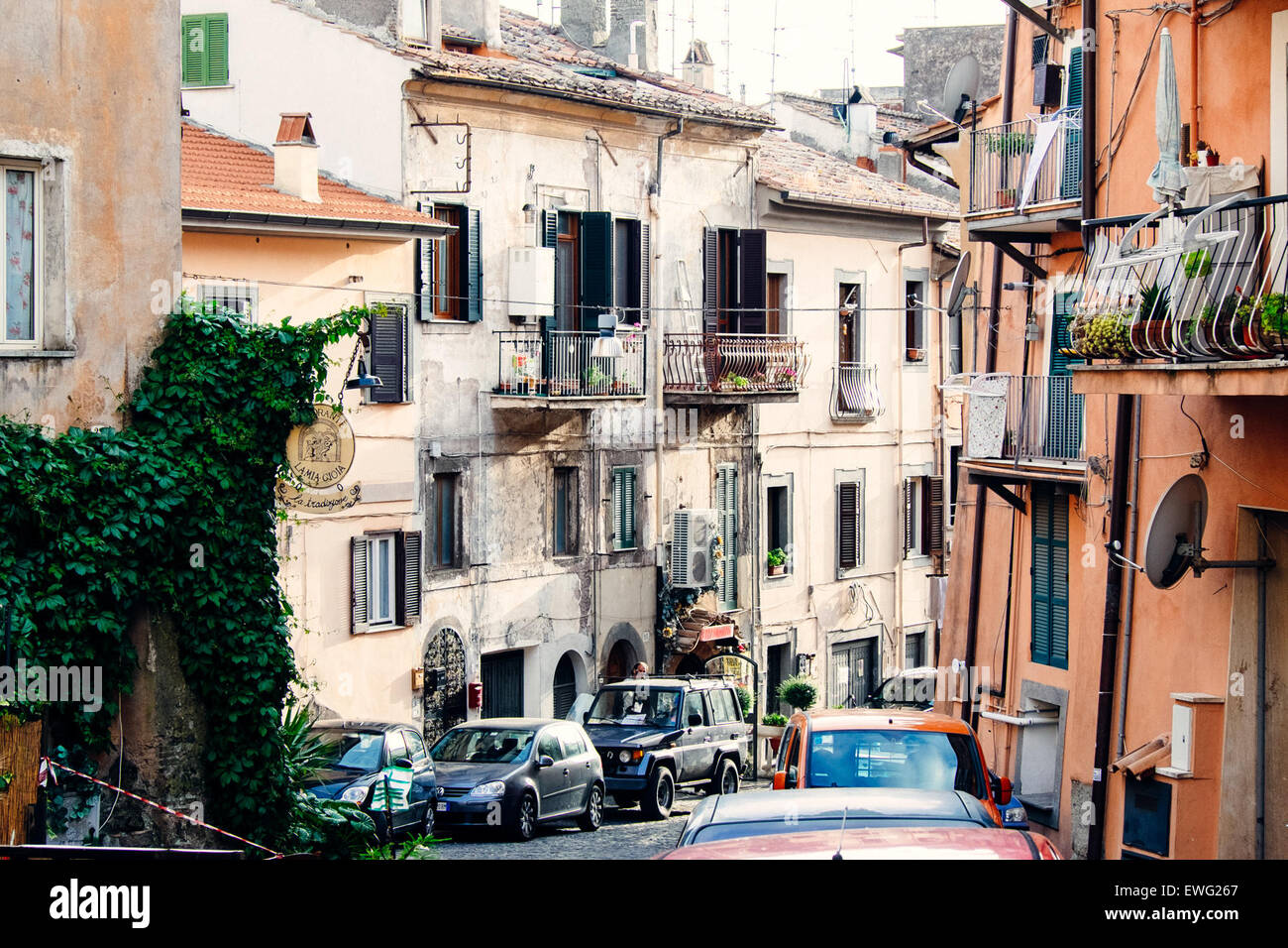 This image features buildings with terraces located on a city street ...