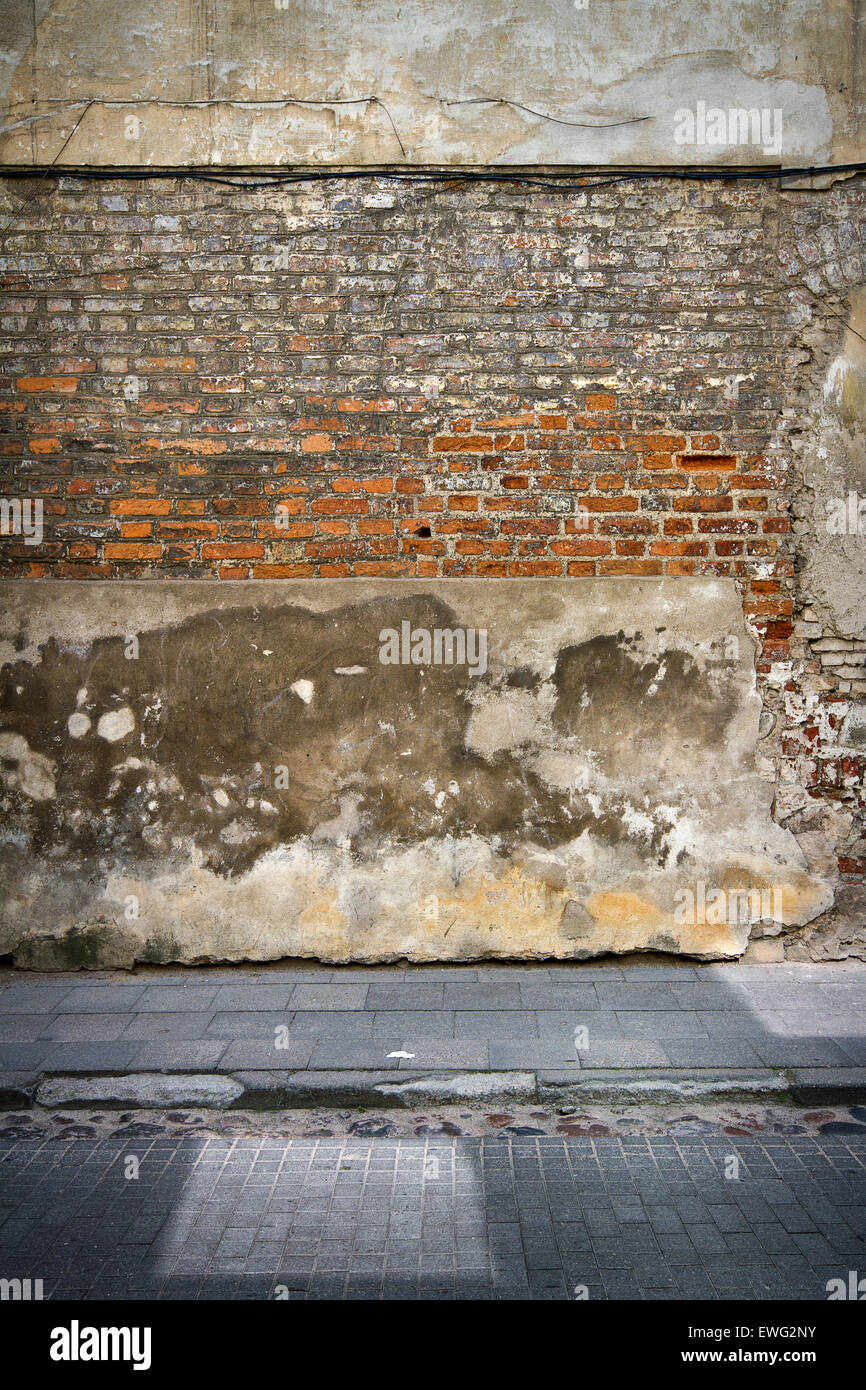 Old weathered wall of bricks and a sidewalk Stock Photo - Alamy