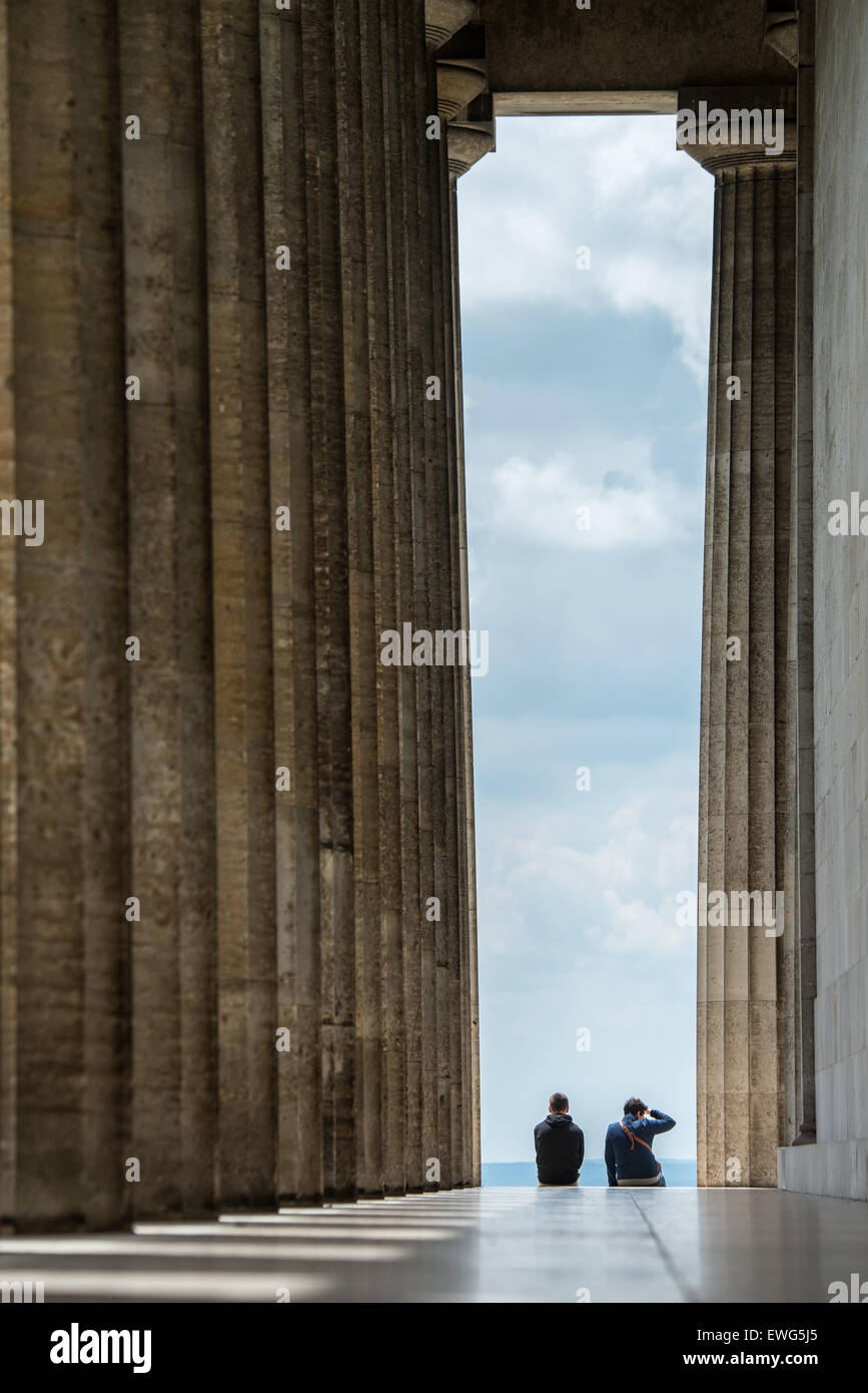Tourists sit between the pillars of the Walhalla memorial in Donaustauf ...
