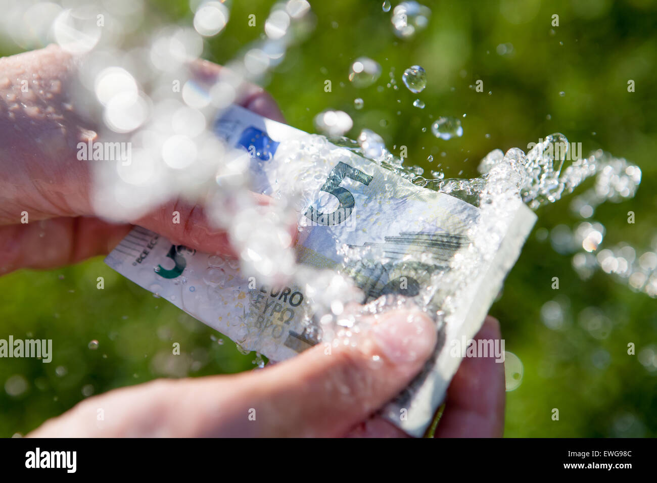 Hand drowning currency hi-res stock photography and images - Alamy