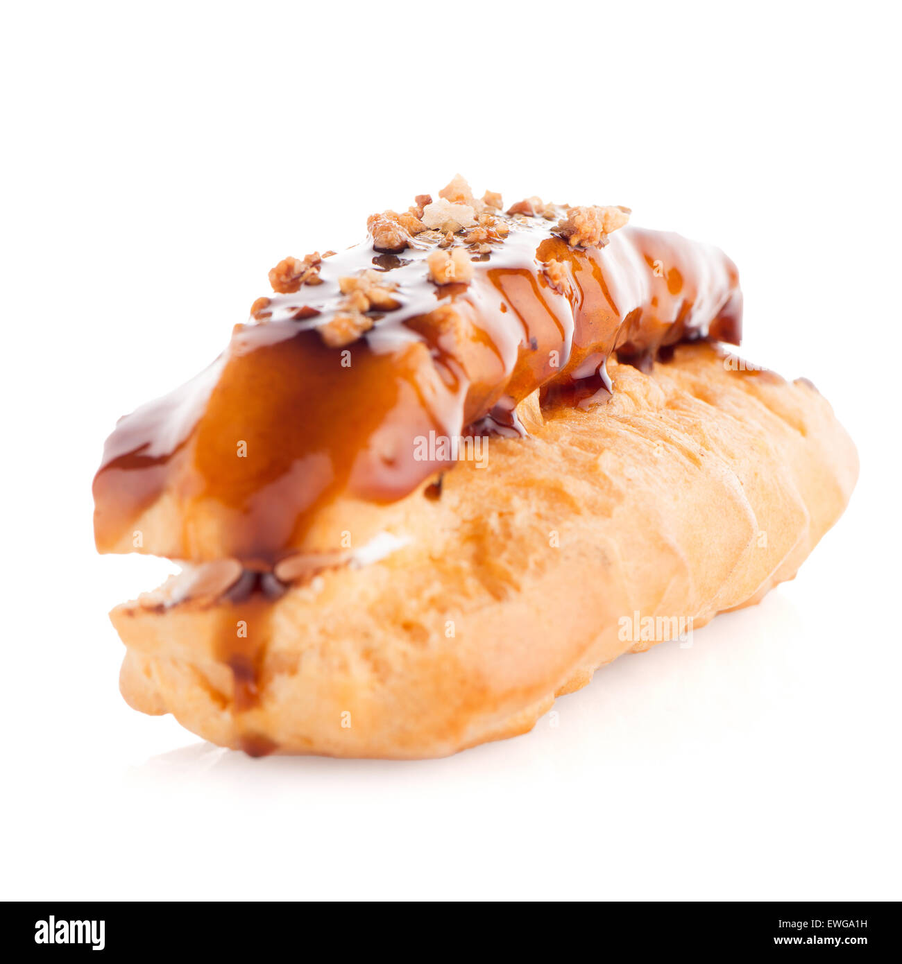 Eclair with caramel decoration on white reflective background Stock ...