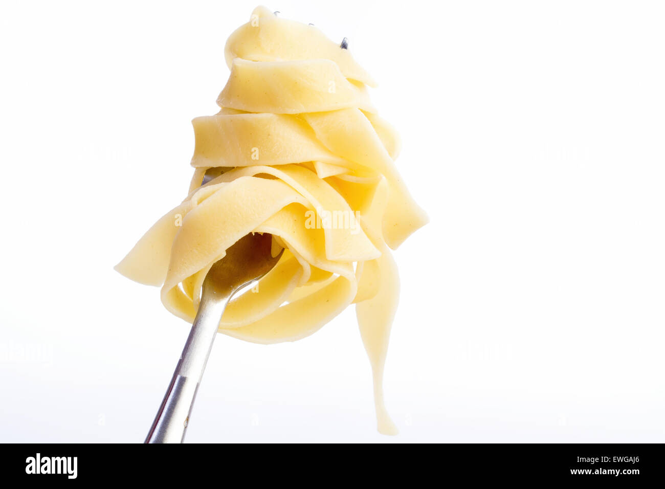 pasta rolled on fork in white background Stock Photo - Alamy
