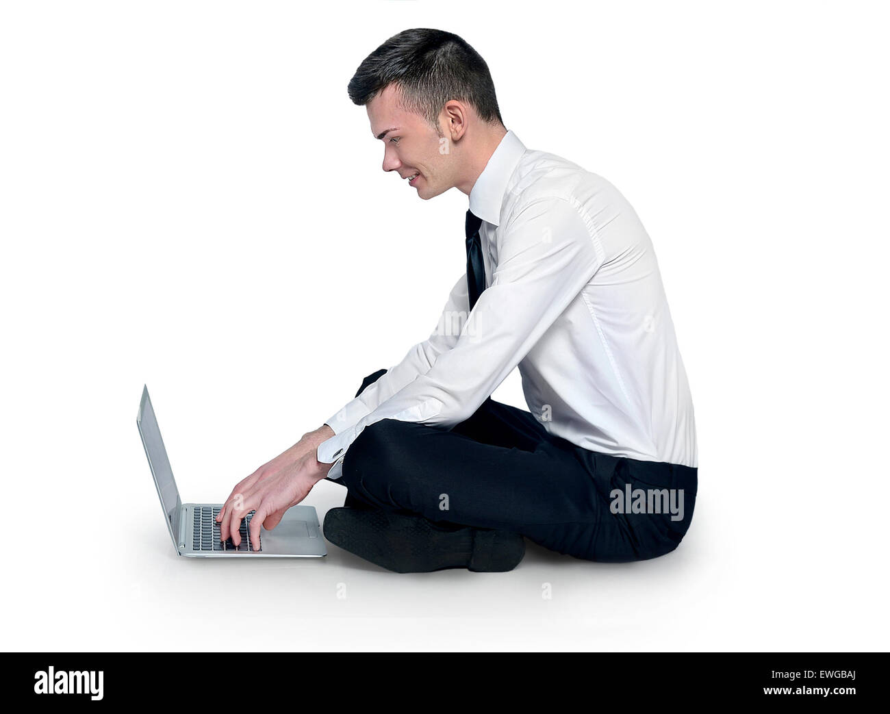 Man using laptop sitting down Stock Photo - Alamy