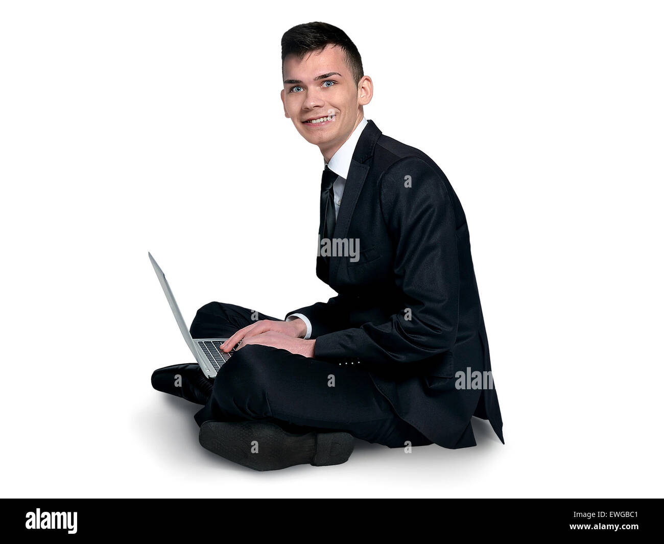 Man using laptop sitting down Stock Photo - Alamy