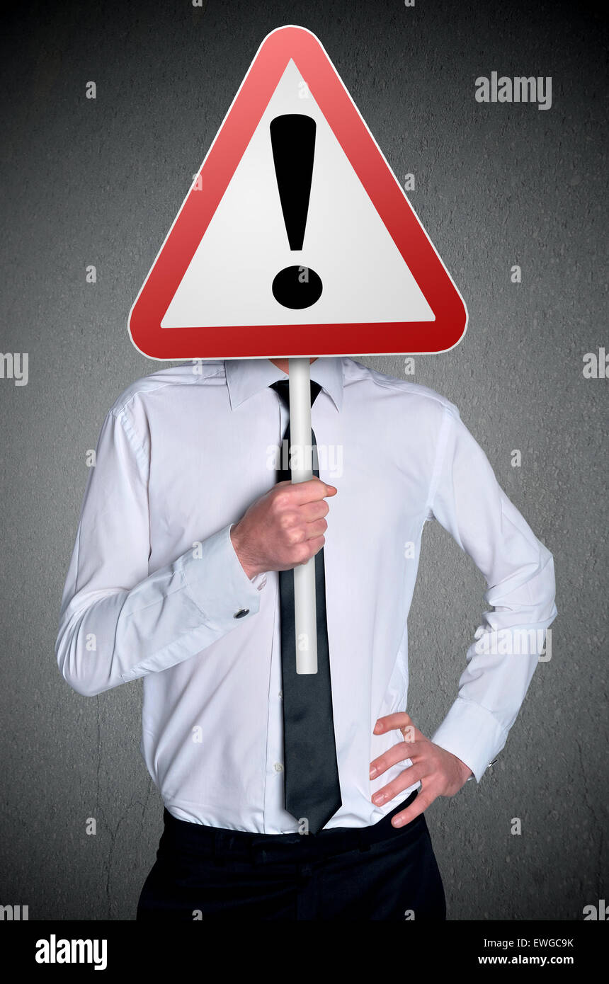 Business man holding exclamation mark Stock Photo - Alamy