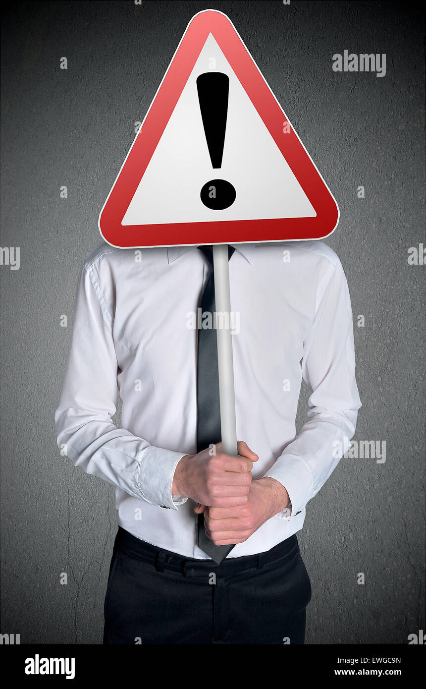Business man holding exclamation mark Stock Photo - Alamy