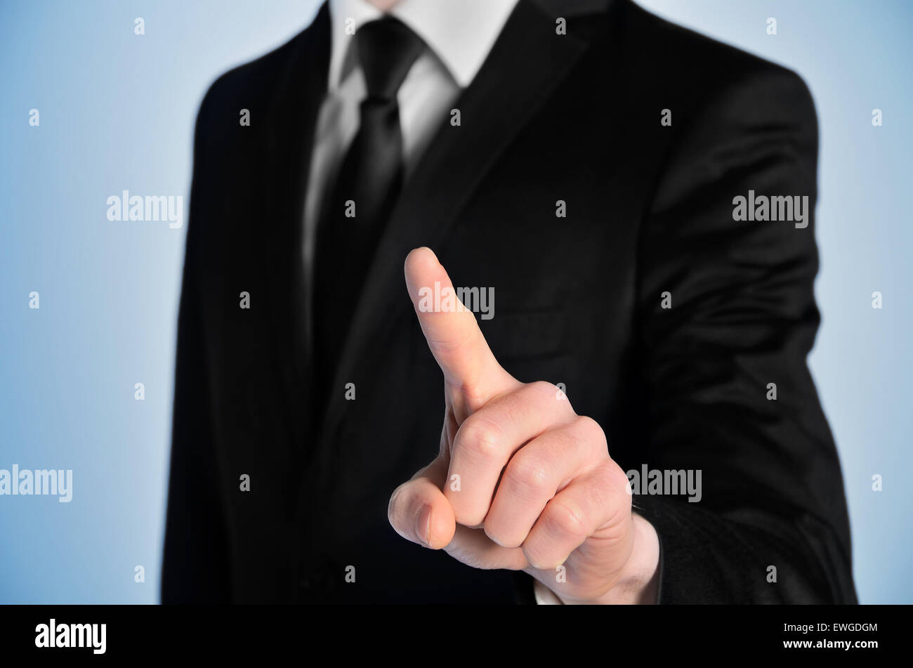Business man press something on blue background Stock Photo - Alamy