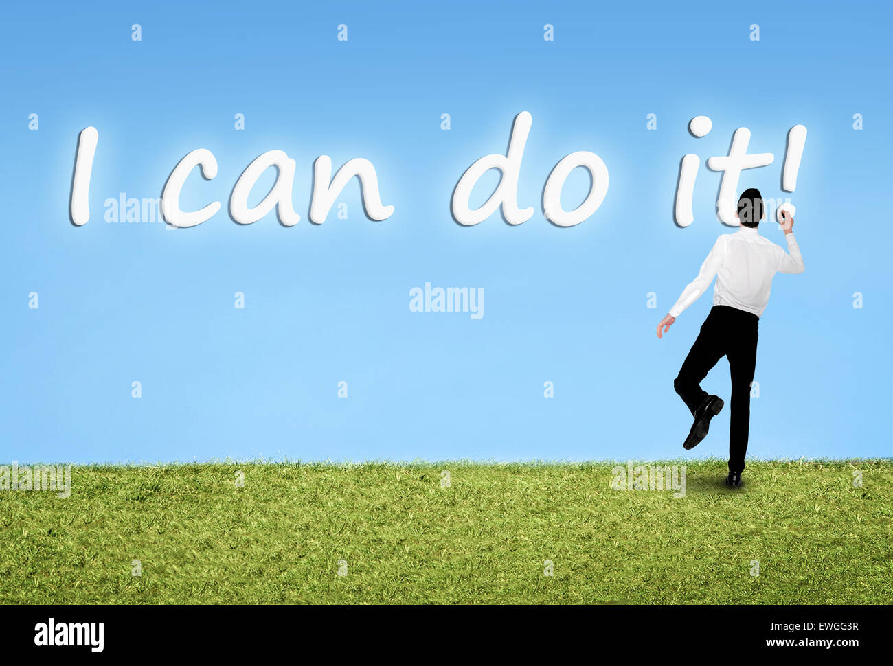 Business man writing on sky I can do it word Stock Photo - Alamy