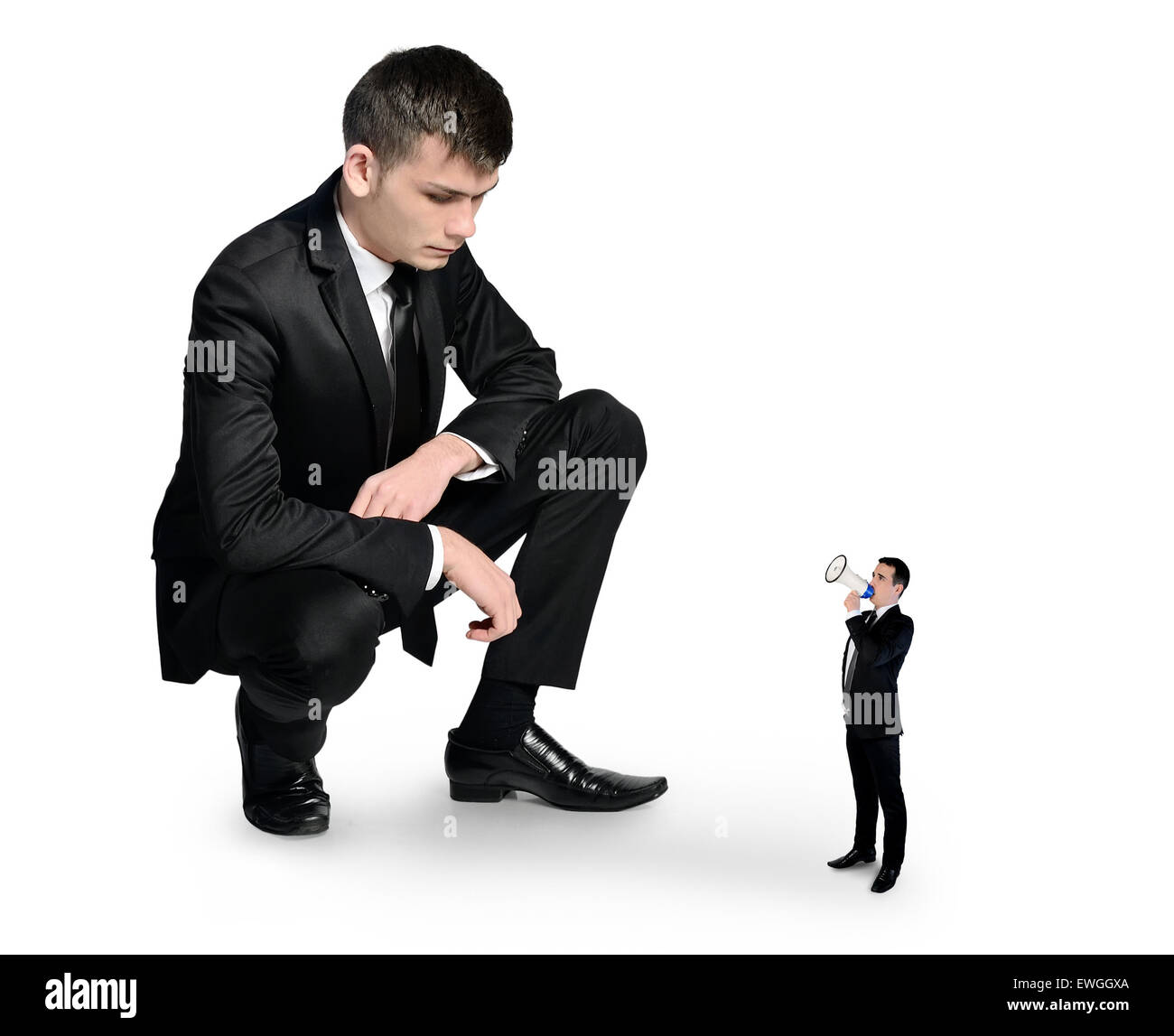 Isolated business man looking at little man Stock Photo - Alamy