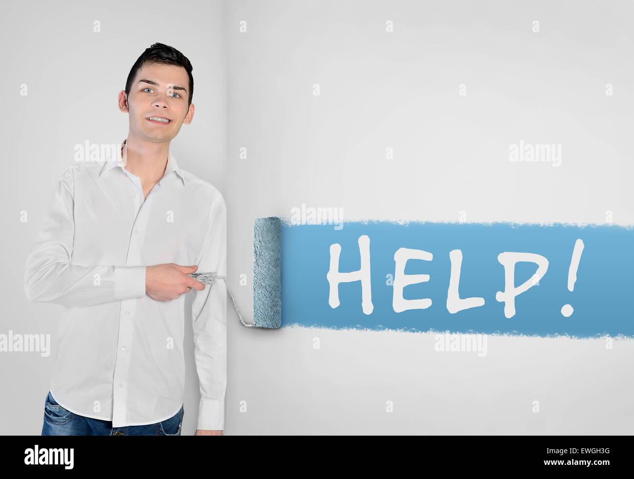Young man painting Help word on wall Stock Photo - Alamy