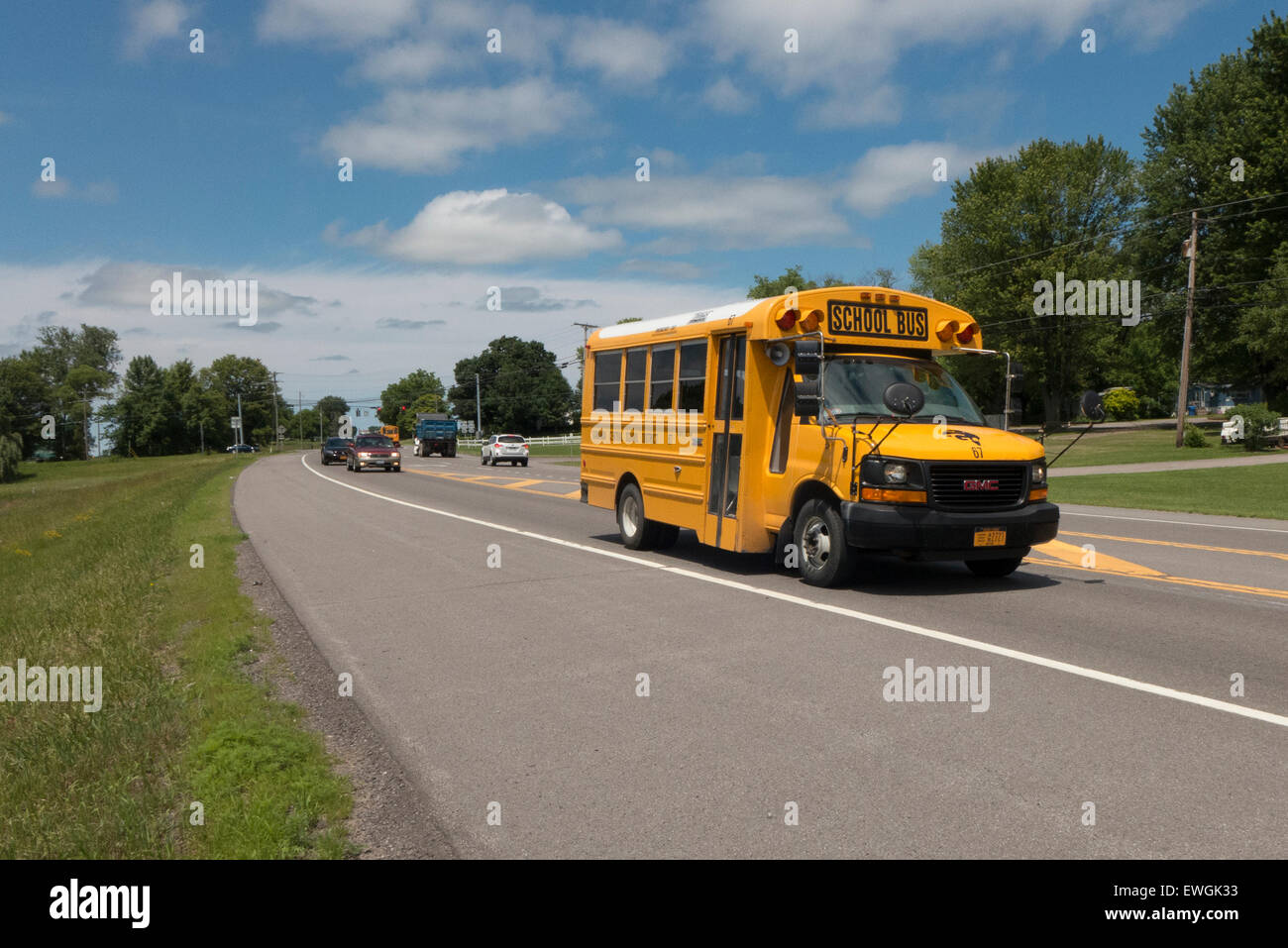 Yellow school bus on the road Stock Photo - Alamy