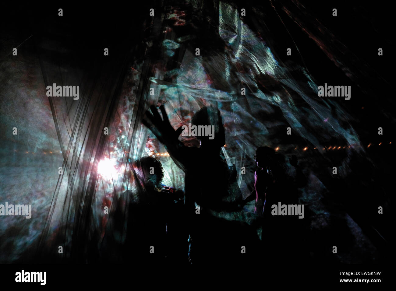 People walking inside a large light and show installation during the ...