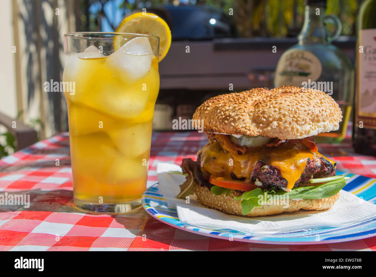 Garden Barbecue. Bacon cheese burger with a glass of ice cold lemonade ...