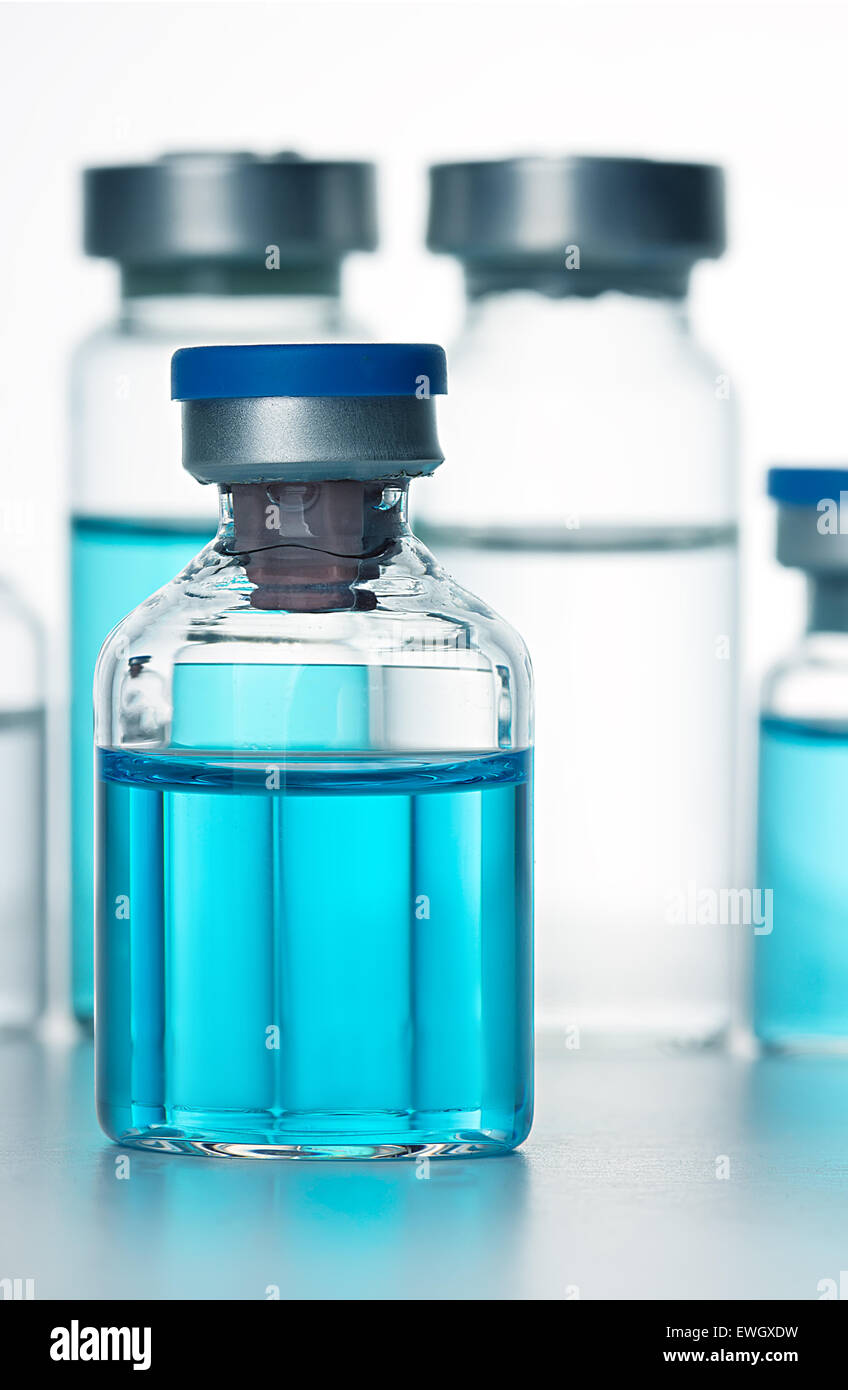 Vials of the vaccine, blue background Stock Photo - Alamy