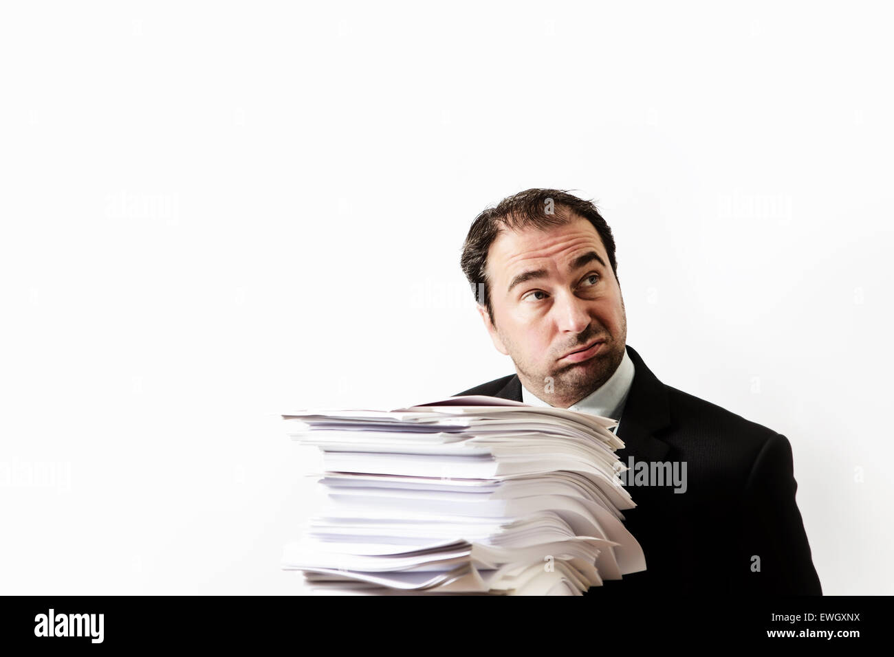 business man holding a stack of paper not looking to pleased Stock ...