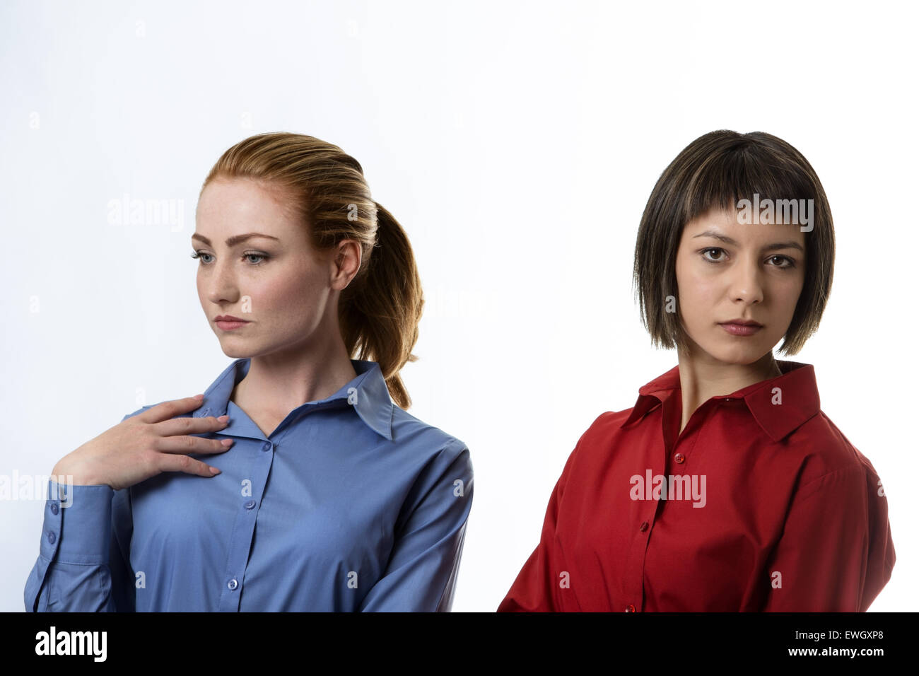 two business woman with different face expressions sanding side by side ...