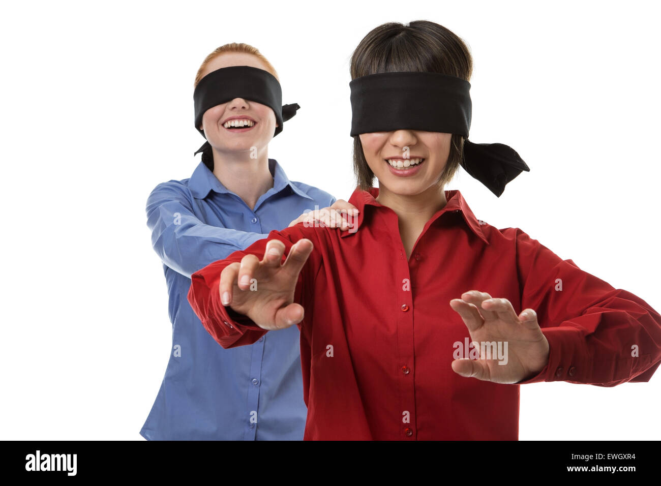 two business woman blind folded leading the other Stock Photo - Alamy