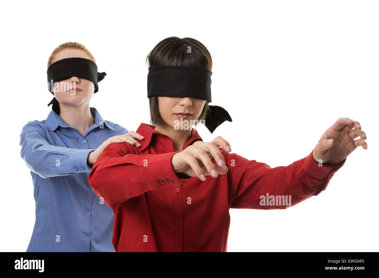 two business woman blind folded leading the other Stock Photo - Alamy