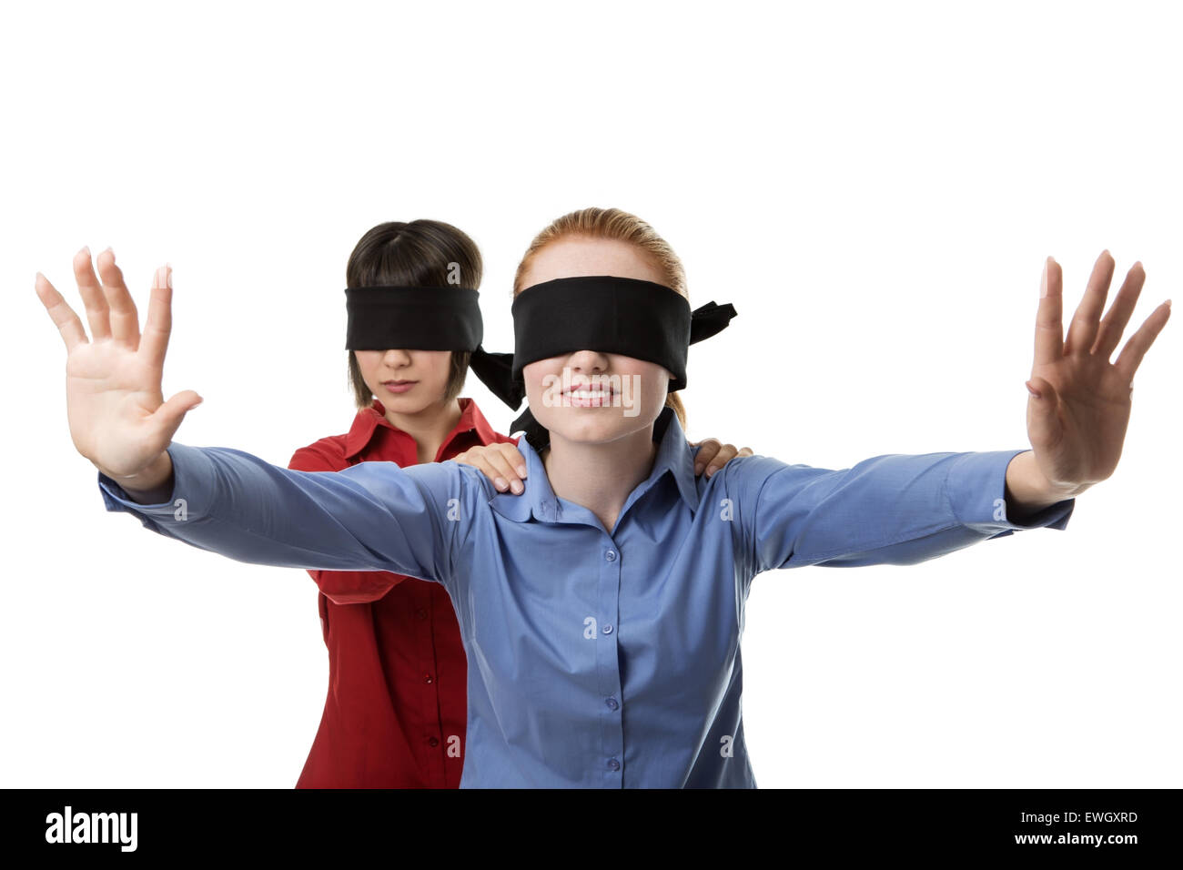 two business woman blind folded leading the other Stock Photo - Alamy