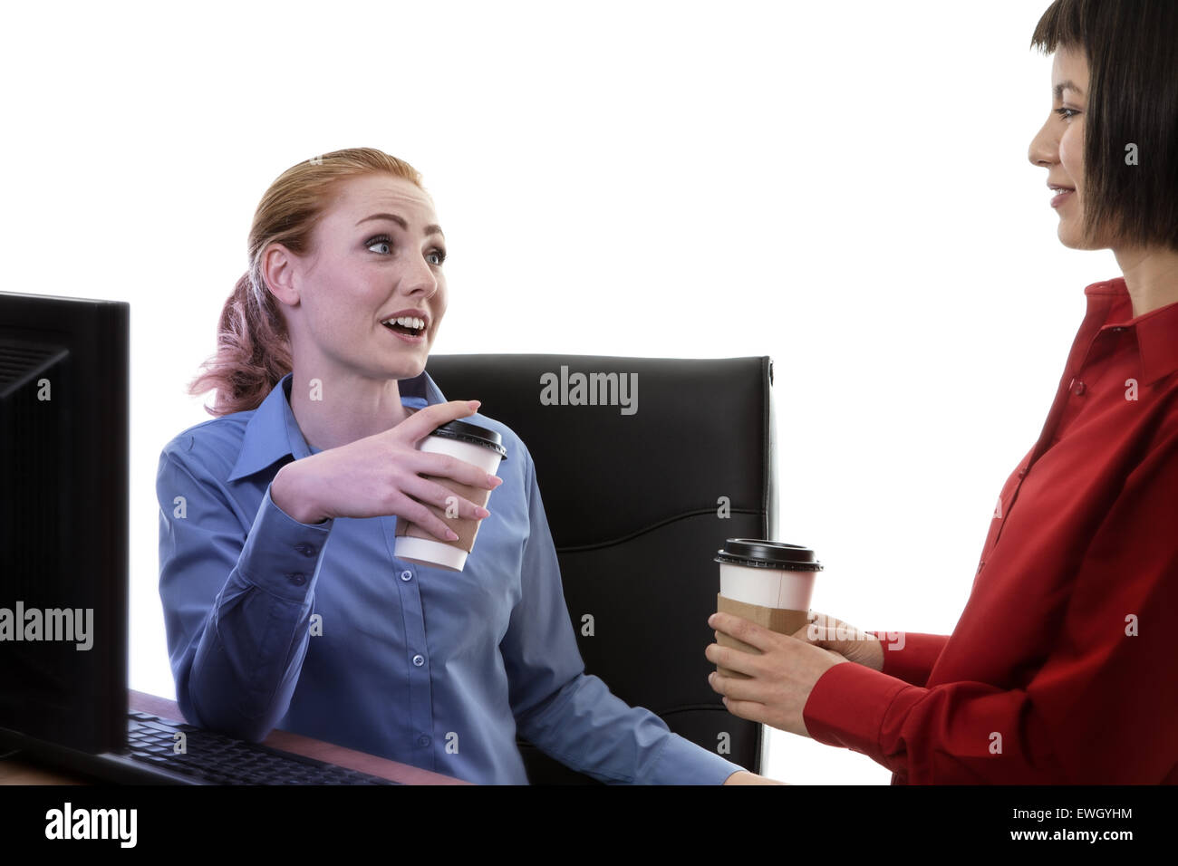 two work colleagues Having a chat and gossip at work over a coffee ...