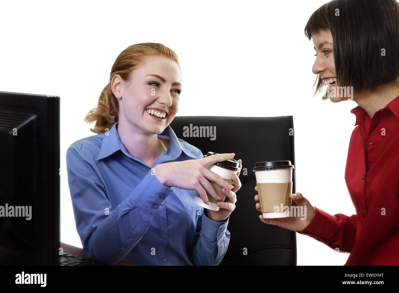 two work colleagues Having a chat and gossip at work over a coffee ...