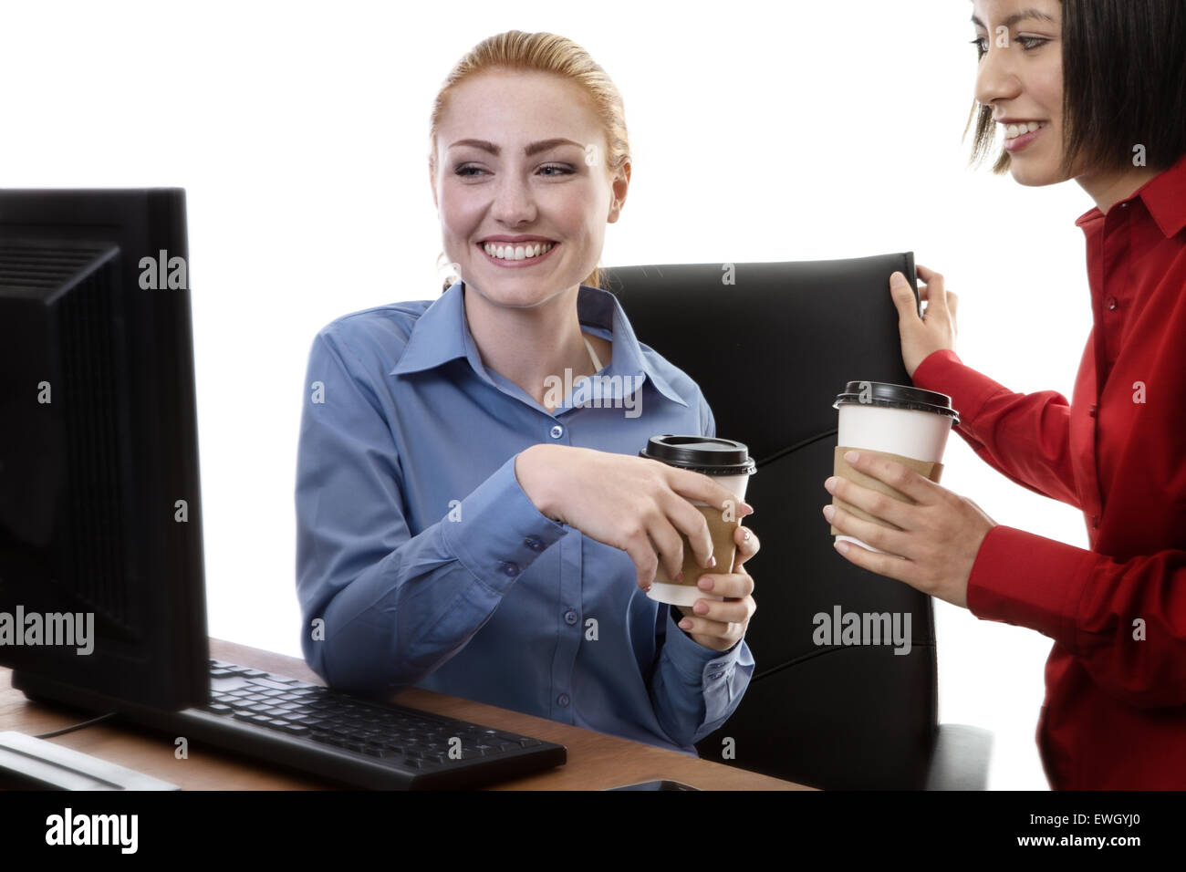 two work colleagues Having a chat and gossip at work over a coffee ...