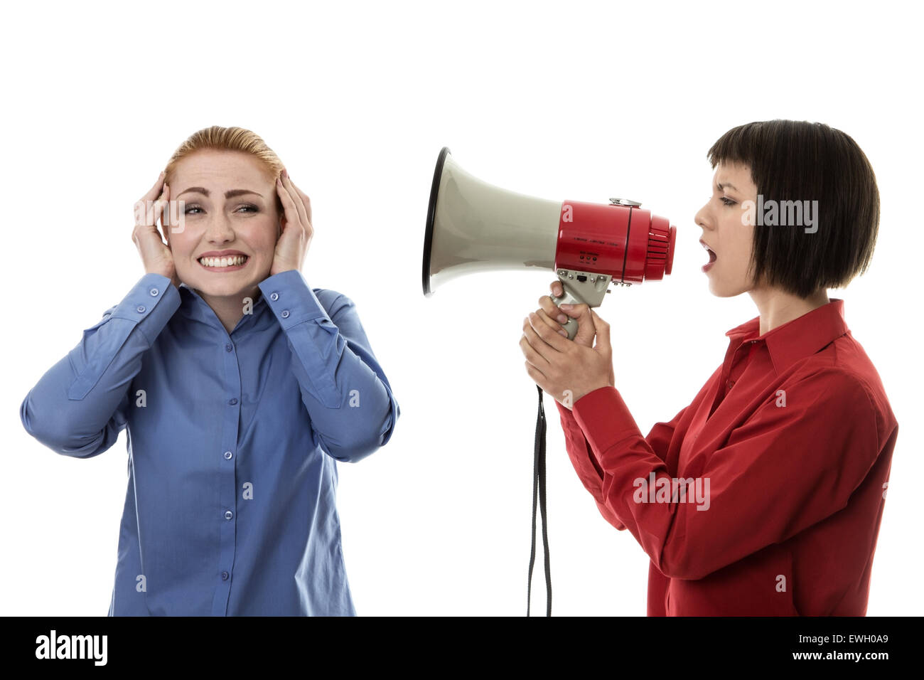Businesswoman shouting at another woman using a bullhorn Stock Photo ...