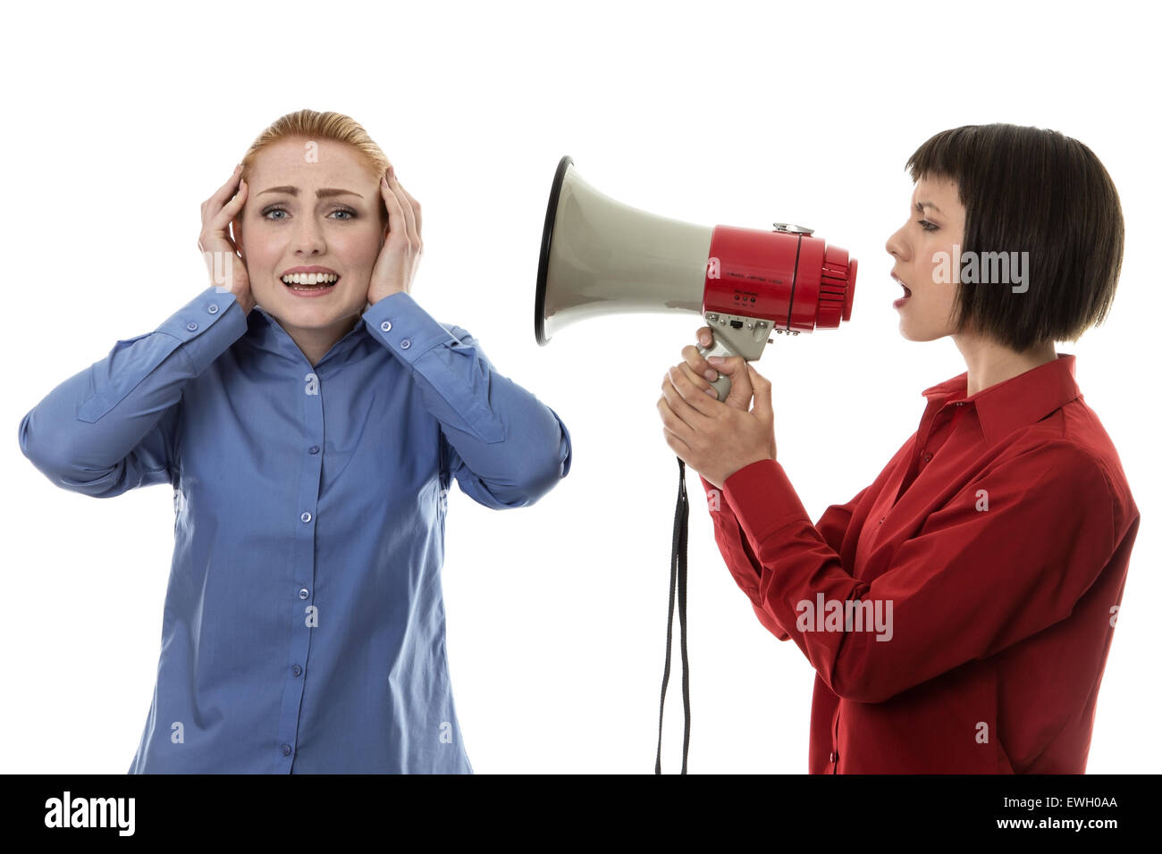 Businesswoman shouting at another woman using a bullhorn Stock Photo ...