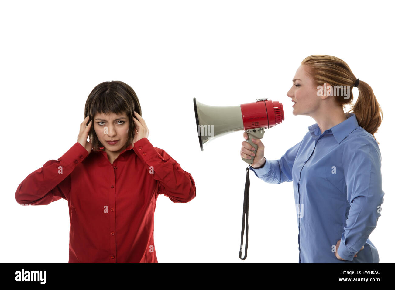 Businesswoman shouting at another woman using a bullhorn Stock Photo ...