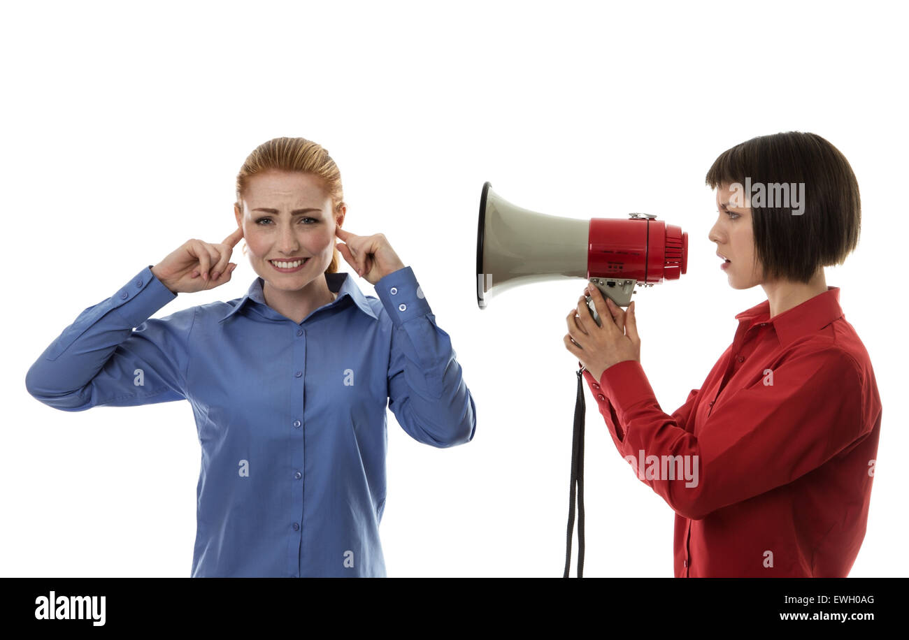 Businesswoman shouting at another woman using a bullhorn Stock Photo ...