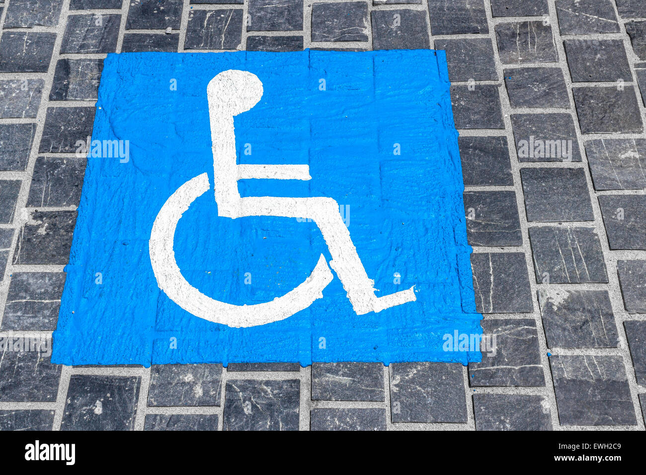 An handicap symbol painted on the stone road Stock Photo - Alamy