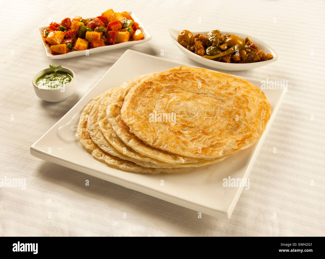 Paratha served with green chutney mixed vegetable and pickles Stock ...