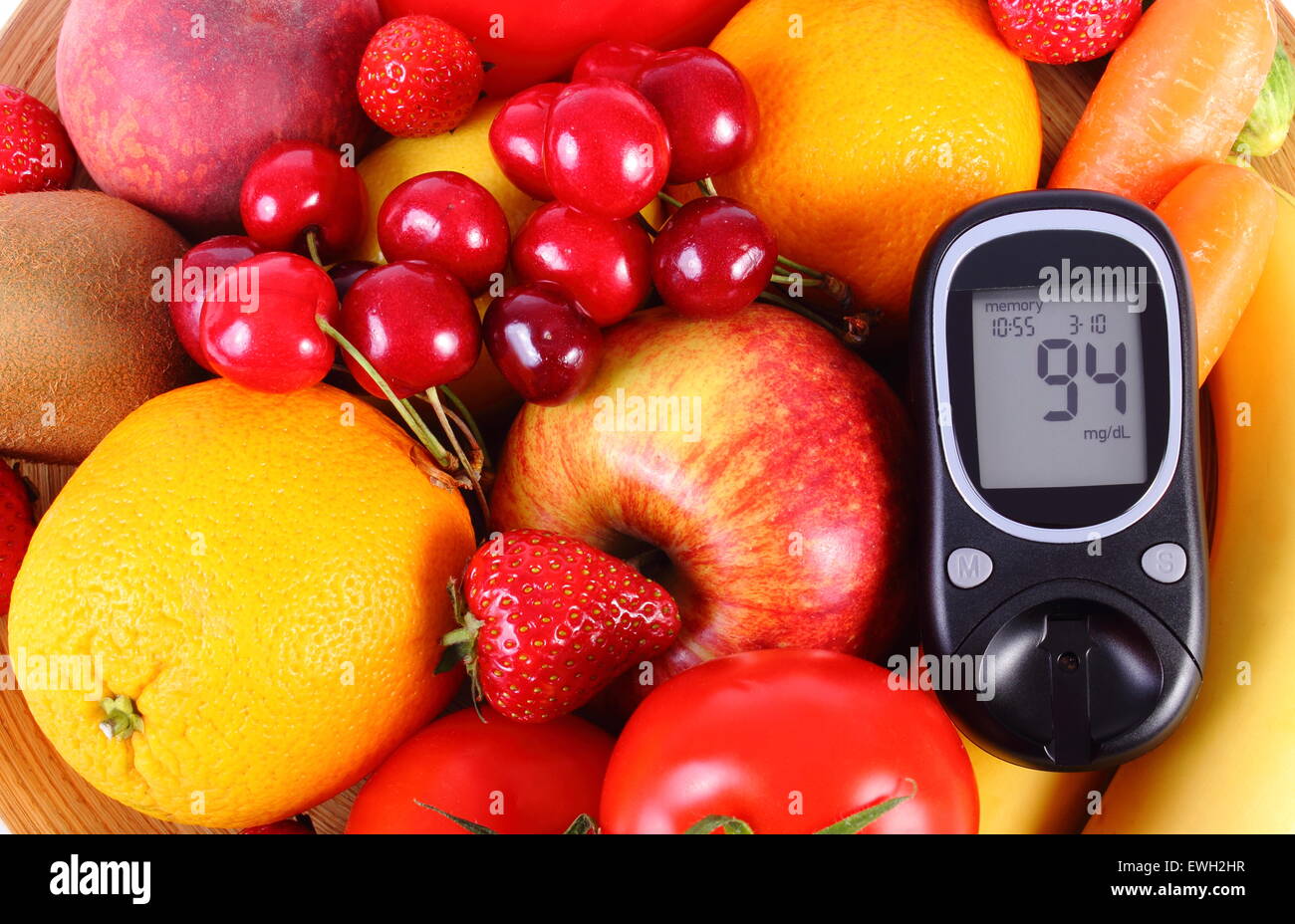 Glucose meter with fresh ripe fruits and vegetables, concept of ...