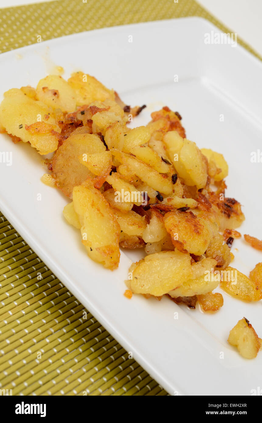 Roasted potatoes on a white plate Stock Photo - Alamy