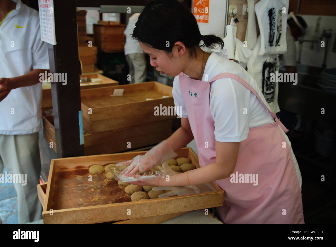 Japanese woman selling japanese pastry (Wagashi) at market Stock Photo ...