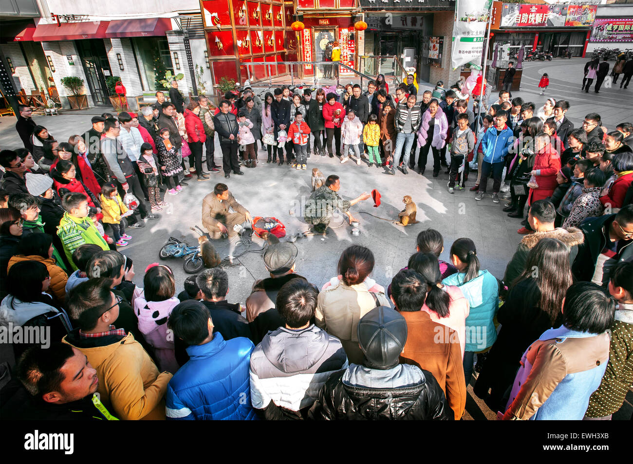 Crowds gather to watch a performing monkey show in Shaoxing, China ...