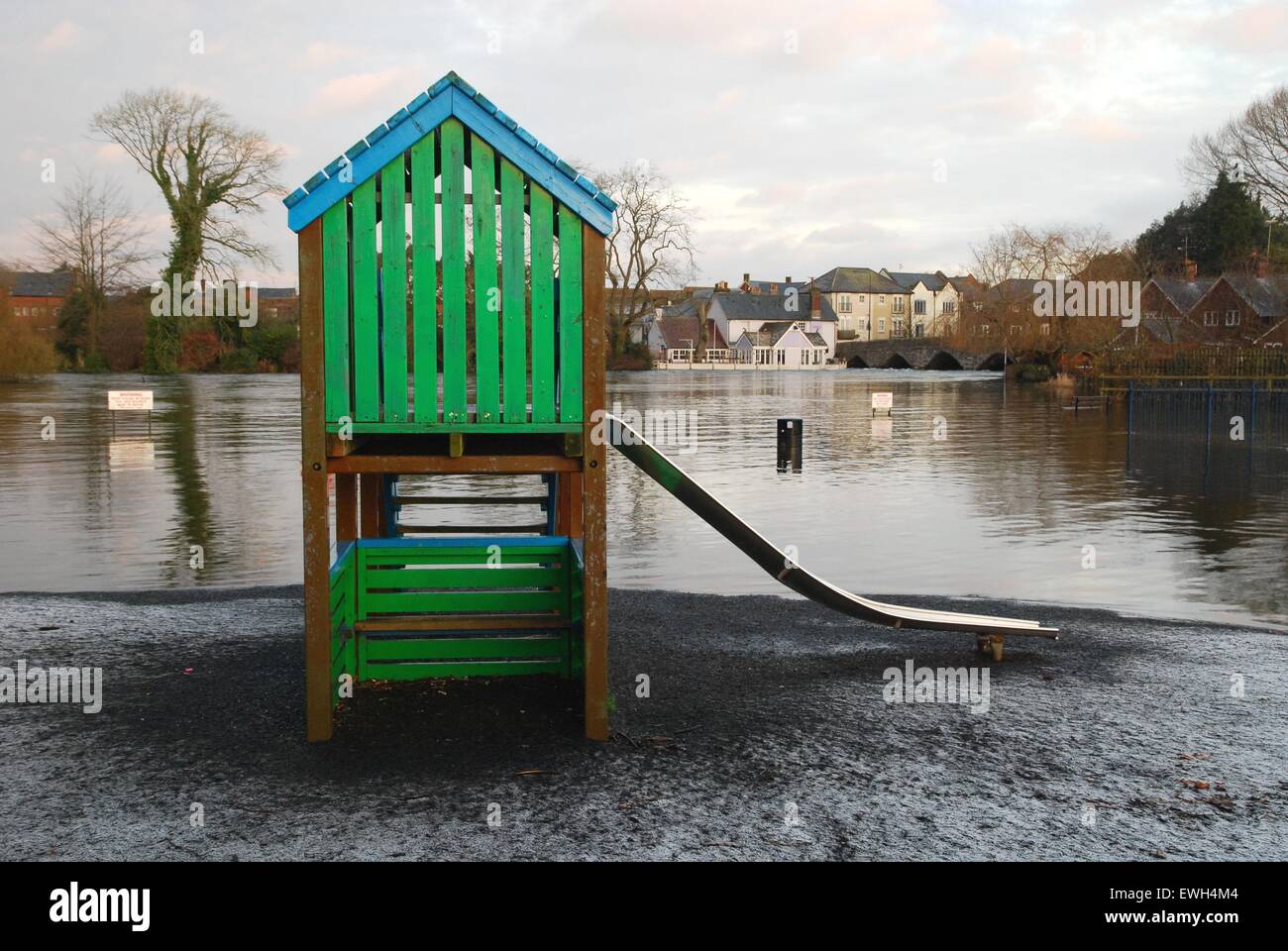 Slide in flooded playground Stock Photo - Alamy