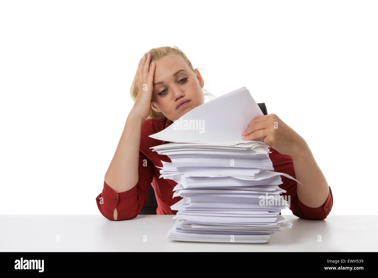 business woman looking at a stack of paper Stock Photo - Alamy