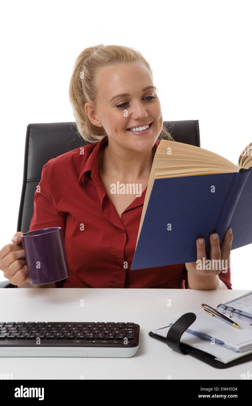 woman at her desk catching up on her reading Stock Photo - Alamy