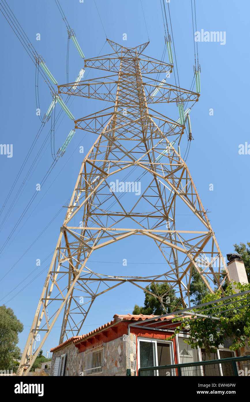 High voltage pylon over a house Stock Photo - Alamy