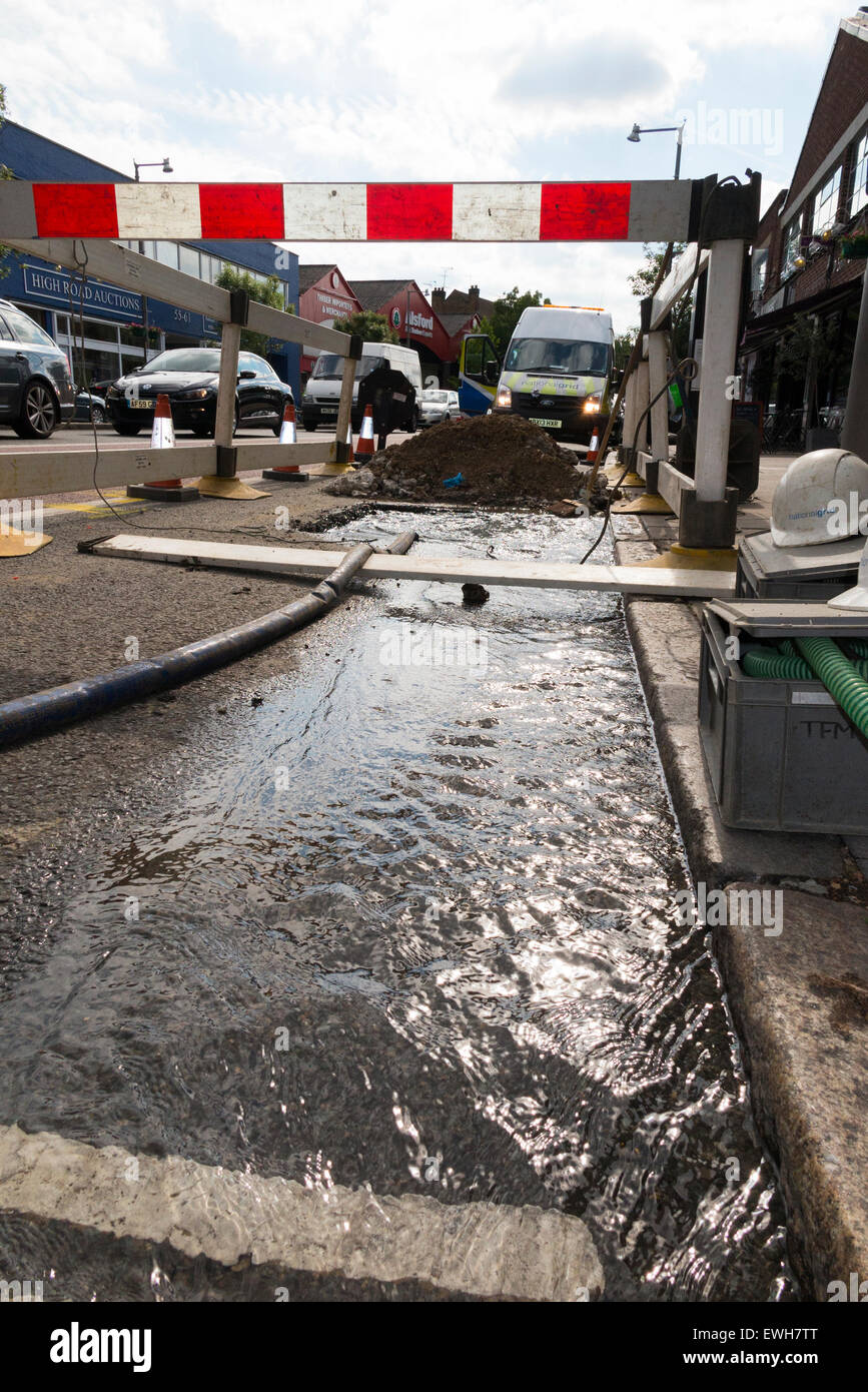 Broken / burst water main leaking pipe allows water to leak and emerge ...