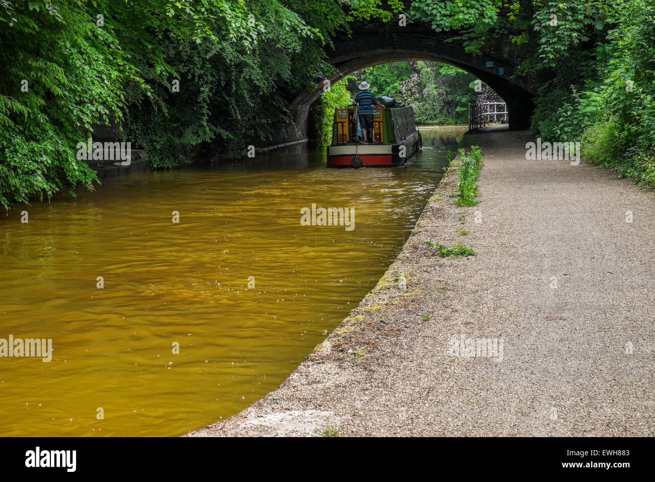 Bridgewater Canal going under a bridge with tow path and railings Stock ...
