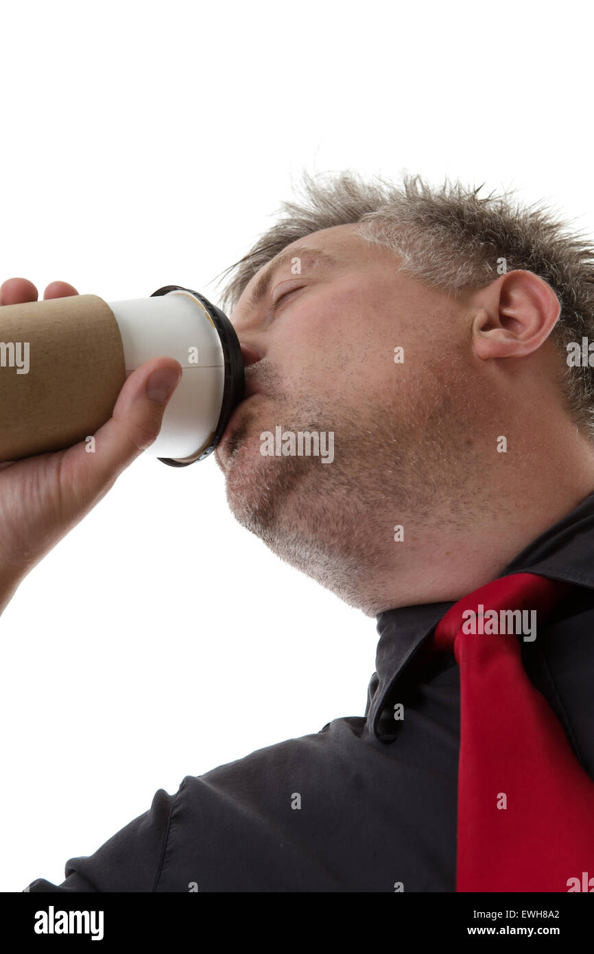 businessman drinking coffee from a paper cup taken from a low angle ...