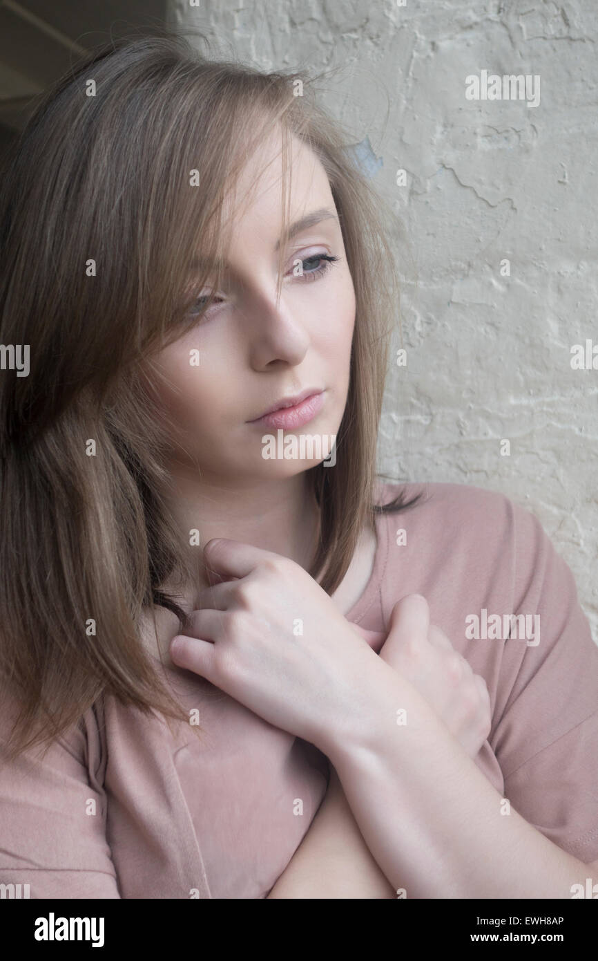 Beautiful young woman hands over heart Stock Photo - Alamy