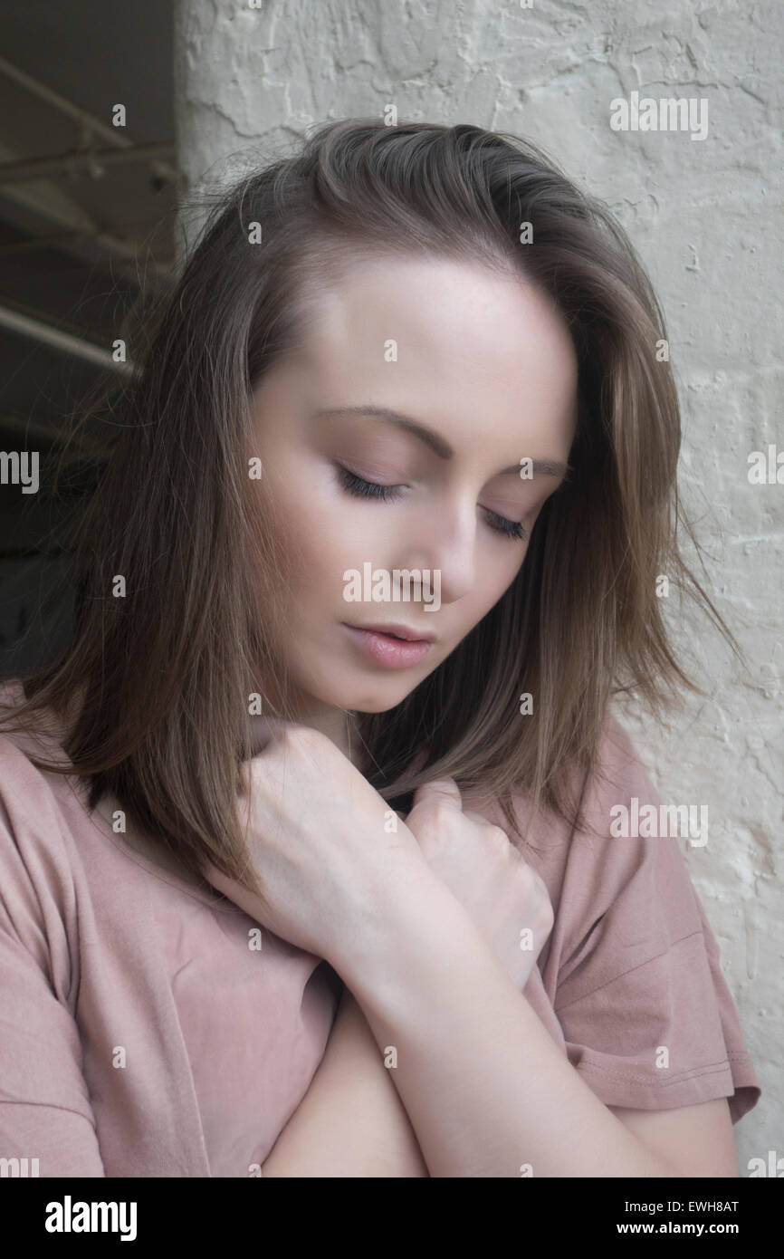 Beautiful young woman hands over heart Stock Photo - Alamy