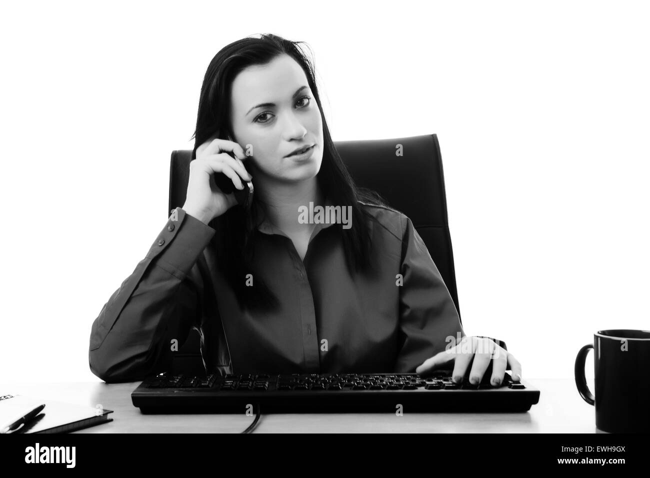woman working at her desk on the phone talking away Stock Photo - Alamy
