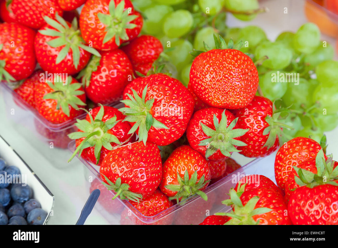 Colorful display of strawberries at a food market Stock Photo - Alamy