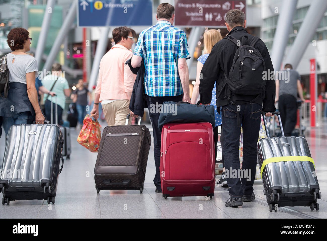 Duesseldorf Airport, Germany. 26th June, 2015. Travellers pull their ...